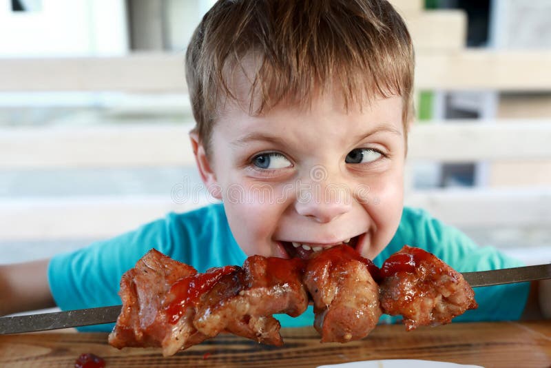 Child Eating Pork Neck Kebab Stock Photo - Image of mouth, hand: 156943166