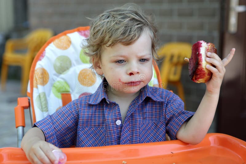 Child eating sweet bun stock image. Image of expression - 97046233