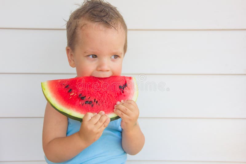 The Child is Eating a Watermelon. Stock Photo - Image of child, happy ...