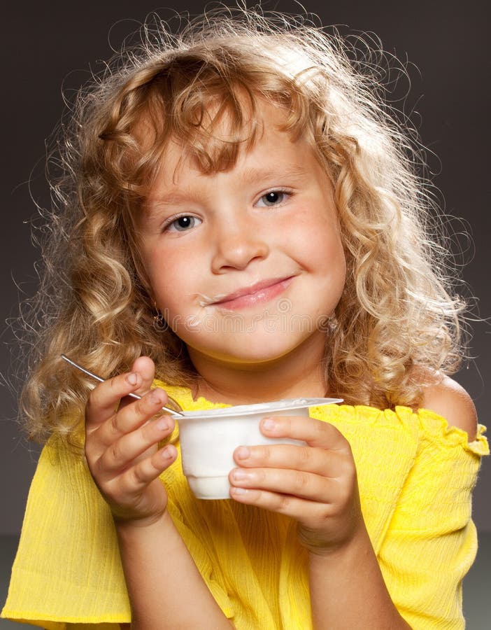 Child eating yogurt stock image. Image of looking, preschooler - 31600731