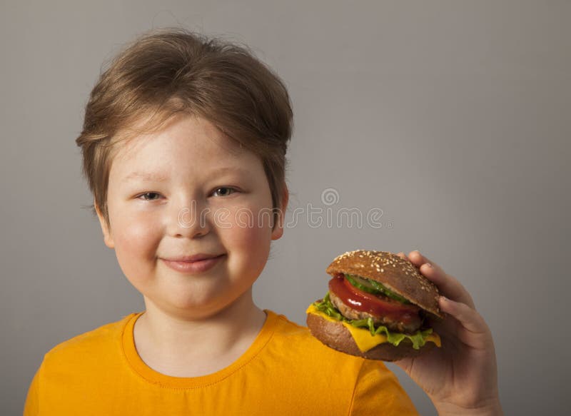 Child Eats Burger on Grey Background. Male Child with Hamburger Stock ...