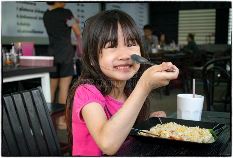 Child Eats Fried Rice with a Spoon in a Authentic Asian Restaurant ...