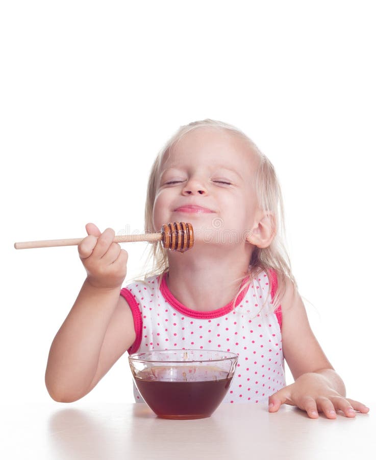 Little girl eat honey stock photo. Image of honey, face - 27015516