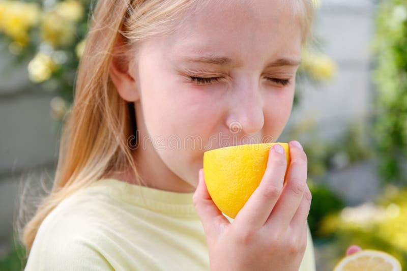 The Child Eats a Sour Lemon. the Girl Wrinkled Her Face Stock Image ...