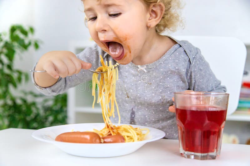 The Child Eats Spaghetti Lunch. Selective Focus Stock Photo - Image of ...