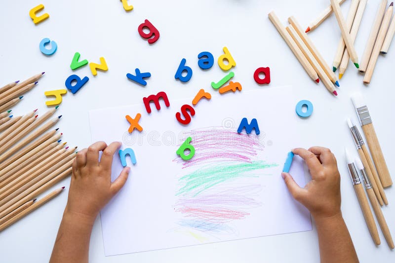 Child Engaged in Creative Alphabet Learning with Colorful Letters and ...