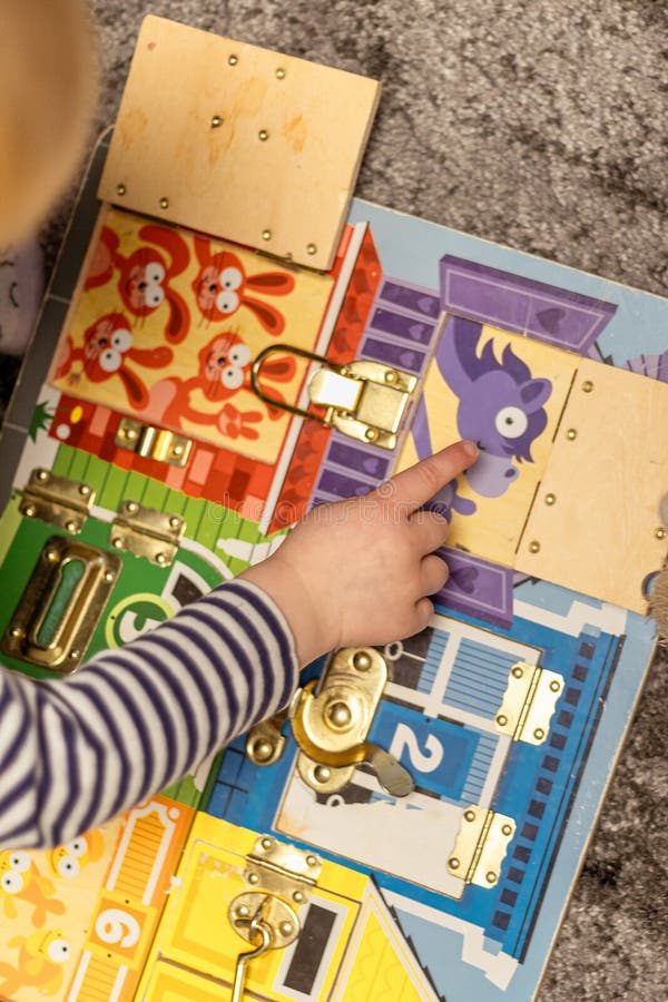 Child Engaged in Playful Learning with Colorful Activity Board ...