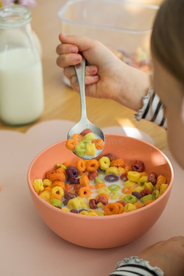 Child Enjoying Colorful Cereal with Milk at Breakfast Table Stock Photo ...