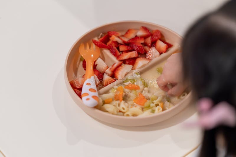 Child Enjoying Colorful Fruit and Pasta on a Plate during Meal Time ...
