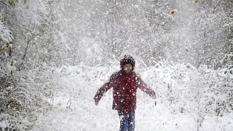 The Child Enjoys the Falling Snow from the Trees in the Park Stock ...