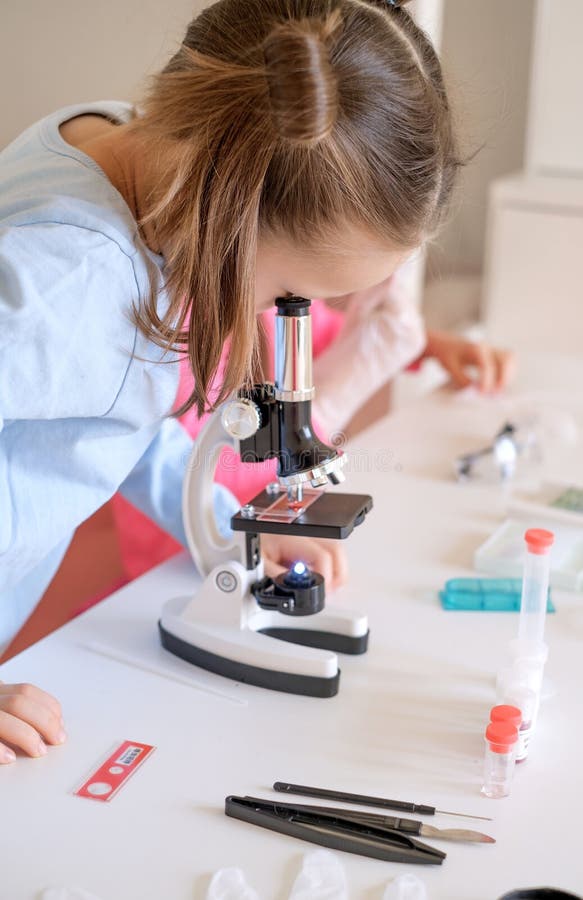 A Child Examines Bacteria Under an Optical Microscope. Stock Image ...