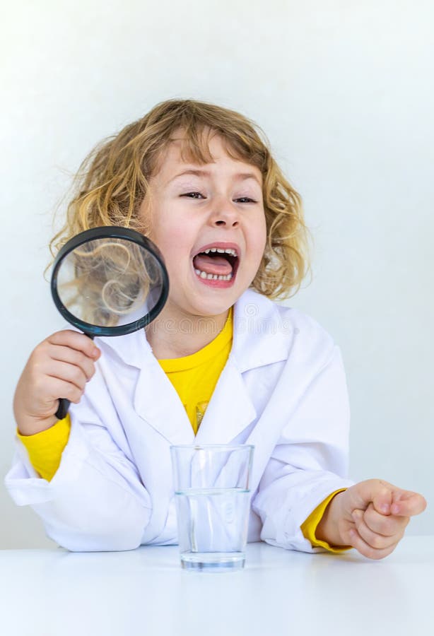 A Child Examines Water with a Magnifying Glass. Selective Focus Stock ...