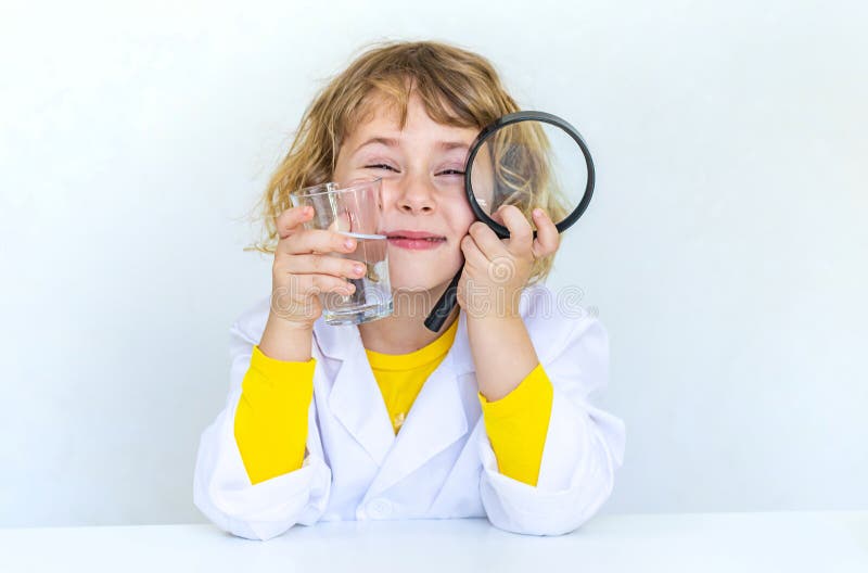 A Child Examines Water with a Magnifying Glass. Selective Focus Stock ...