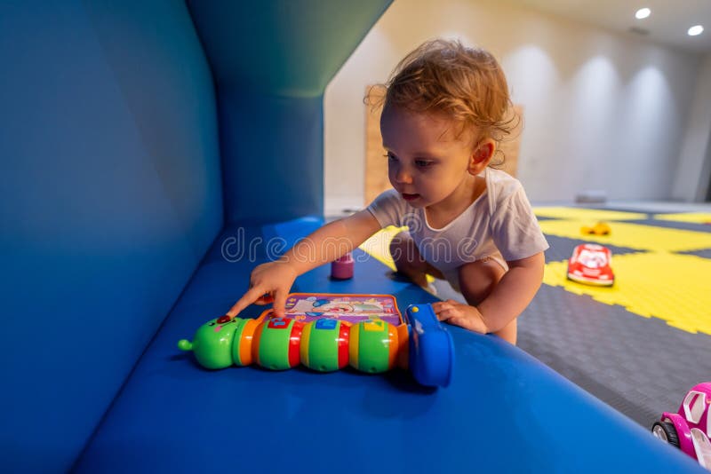 Child Exploring Colorful Toy in Engaging Playroom Environment. Concept ...