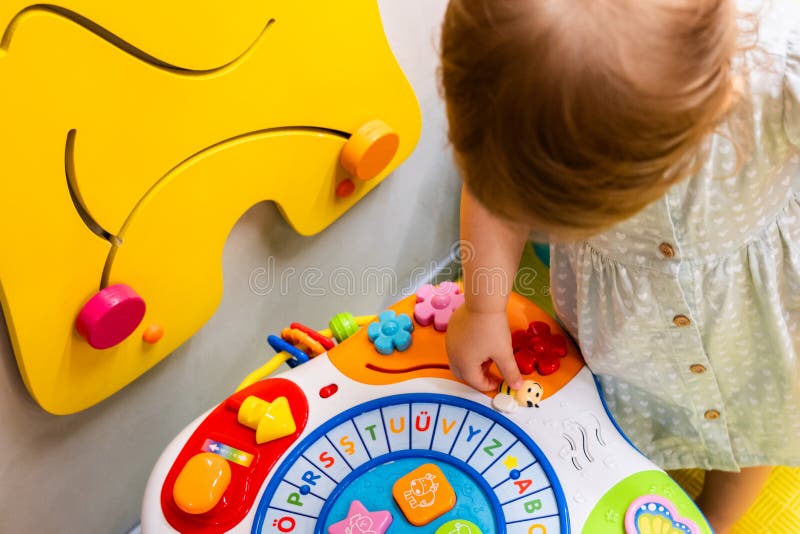 Child Exploring Shapes and Colors with Educational Toy. Concept of ...