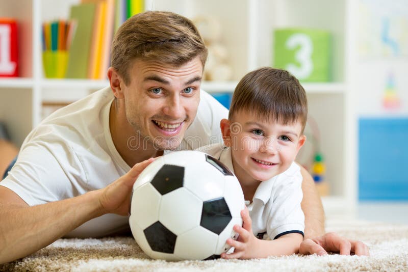 Child and Father Playing with Football Stock Photo - Image of caucasian ...