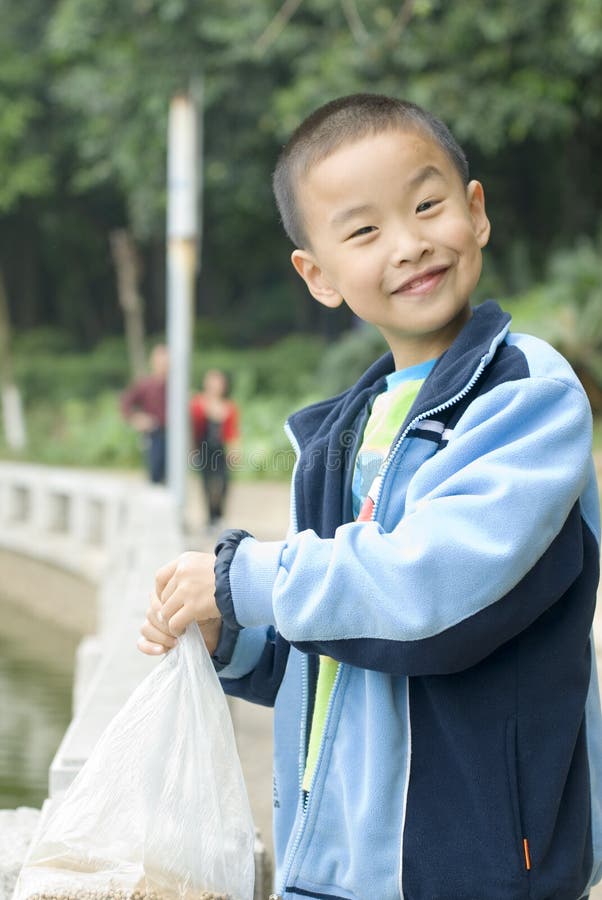 A child at feeding fish stock photo. Image of innocents - 8985852