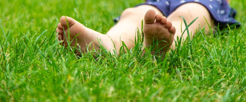 Child Feet on the Grass. Selective Focus Stock Photo - Image of foot ...