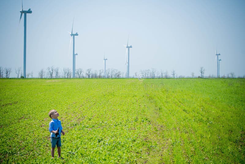 Child on the Field with Wind Generators Stock Image - Image of ...