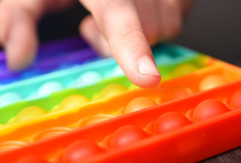 Child Finger Presses the Ball on the Color Pop it Stock Photo - Image ...