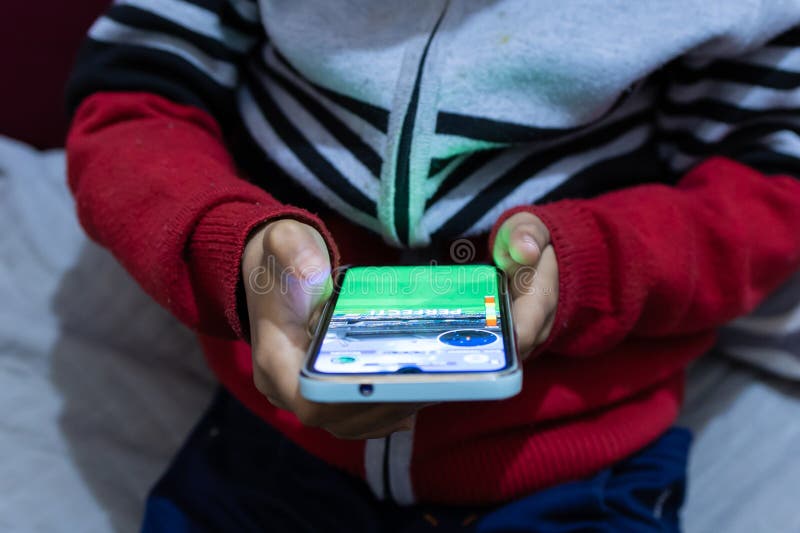 Child Finger Tapping Mobile Phone Screen while Playing Online Game at ...