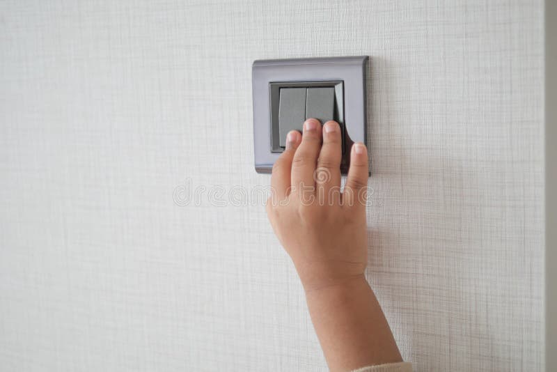 Child Finger Turning on Lighting Switch with Copyspace Stock Photo ...