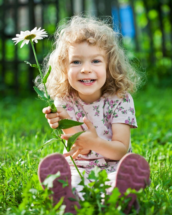 Happy Beautiful Little Girl with Flowers. Stock Photo - Image of ...