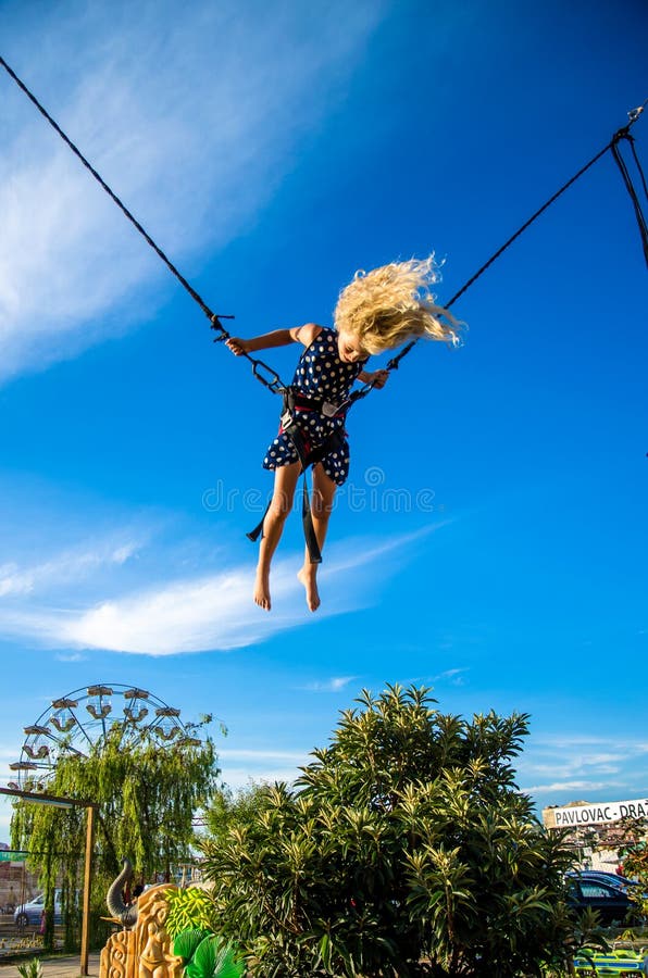 Child Flying on Bungee Attraction Stock Photo - Image of high, outdoor ...