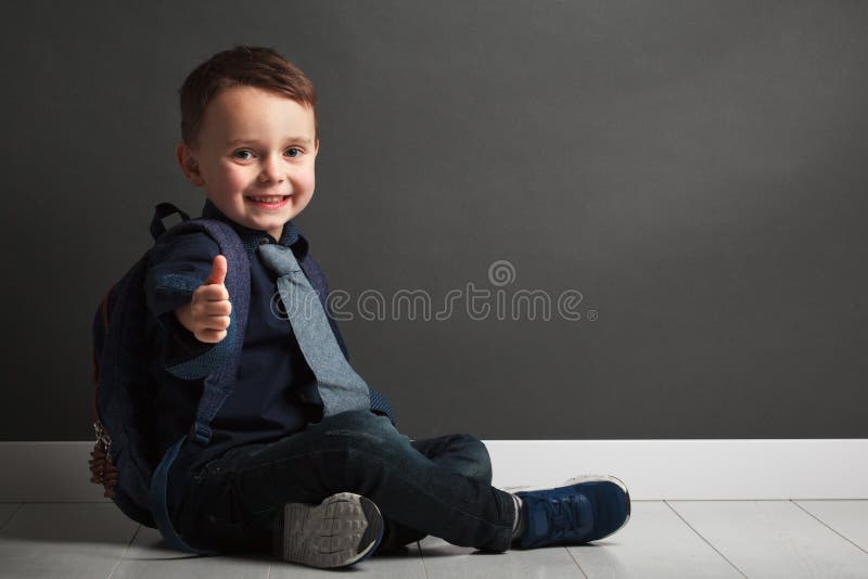 Child Getting Ready for School. Sits on the Floor with a Backpack with ...
