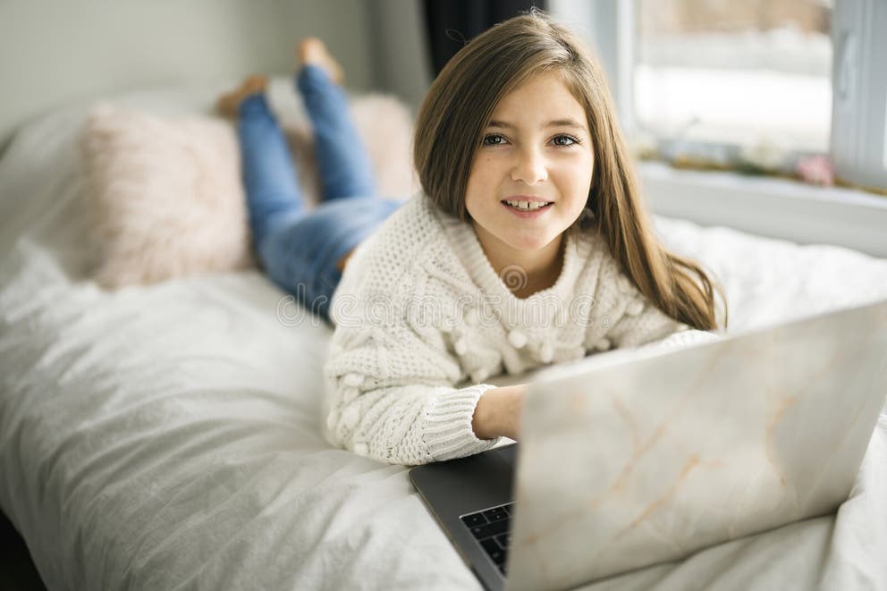 Child Girl with Computers on Bed at Home Stock Photo - Image of ...