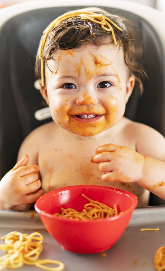 Child Girl, Eating Spaghetti for Lunch and Making a Mess at Home in ...