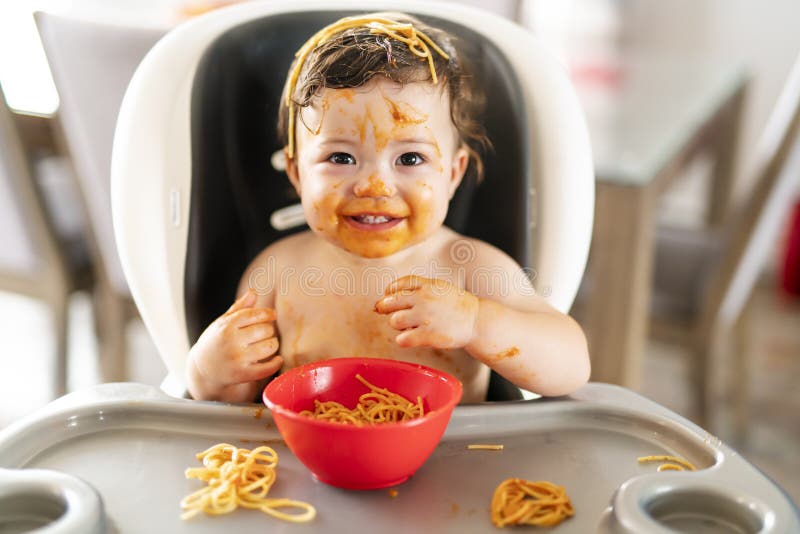Child Girl, Eating Spaghetti for Lunch and Making a Mess at Home in ...