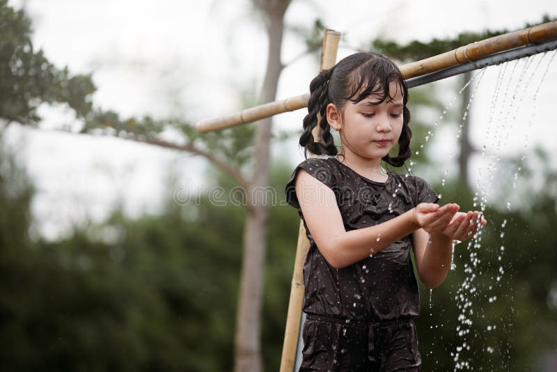 Child Girl Has Fun Playing in Water Outdoors Stock Photo - Image of ...