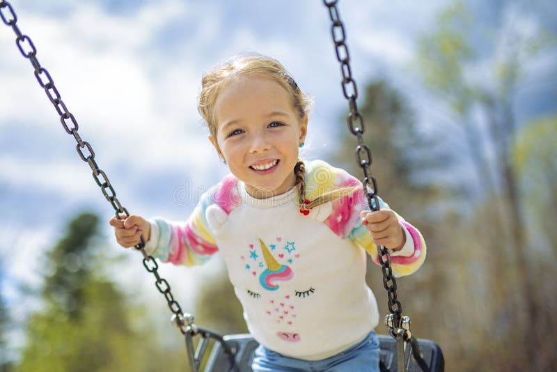 Child Girl, Playing on Swing Playground in Spring Time Stock Image ...