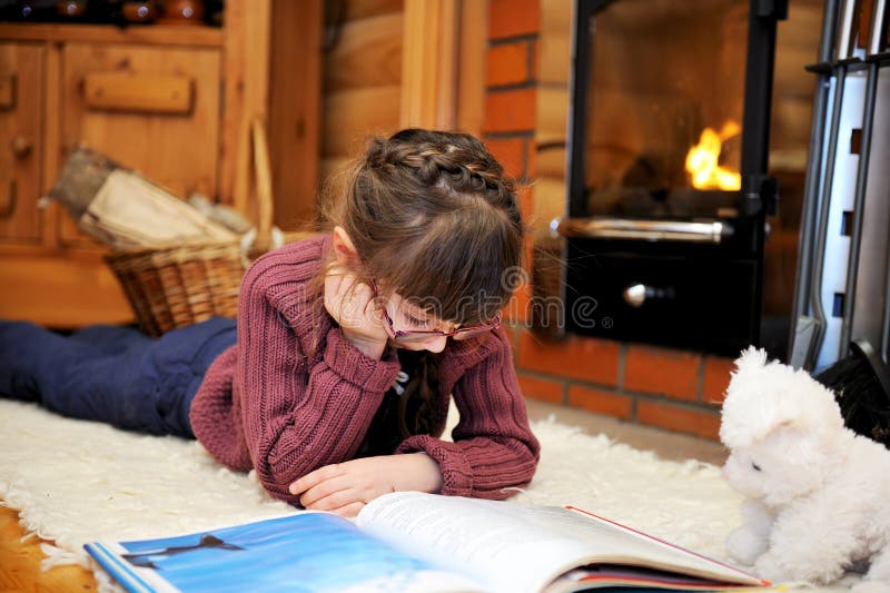 Child Girl is Reading in Front of Fireplace Stock Image - Image of ...