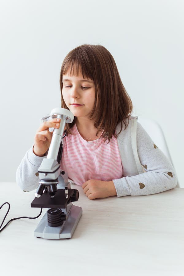 Child Girl in Science Class Using Digital Microscope. Technologies ...