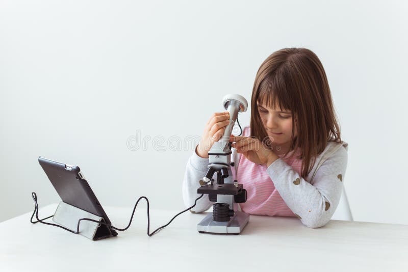 Child Girl in Science Class Using Digital Microscope. Technologies ...