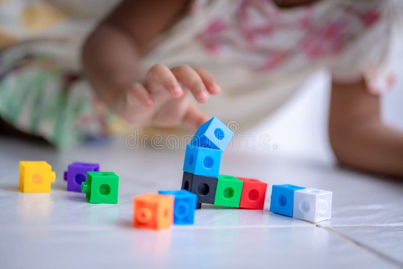 Child Girl is Using Hands Assembling Colored Cubes Stock Image - Image ...