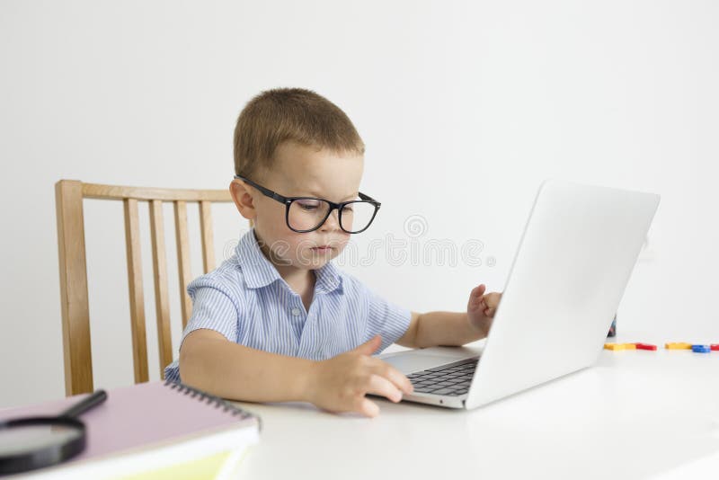 A Child with Glasses is Focused on Completing a Task. the Child Does ...