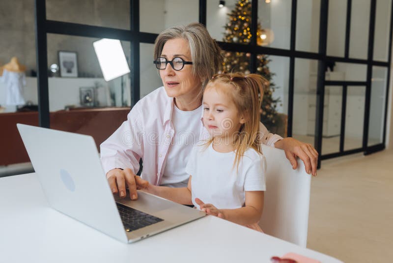 Child and Granny Looking at the Camera with Laptop Stock Image - Image ...
