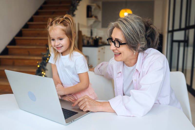 Child and Granny Looking at the Camera with Laptop Stock Photo - Image ...