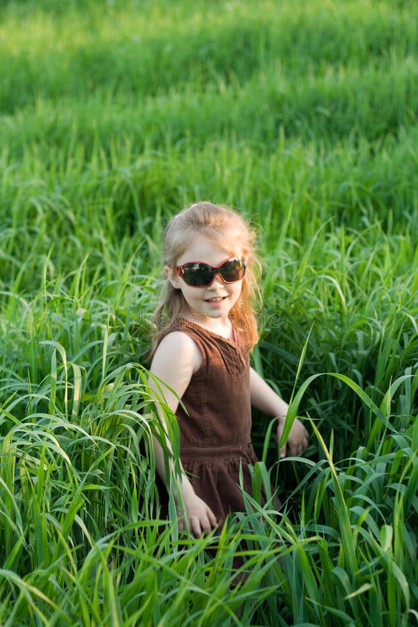 The child in a grass stock photo. Image of girl, spontaneity - 5389746
