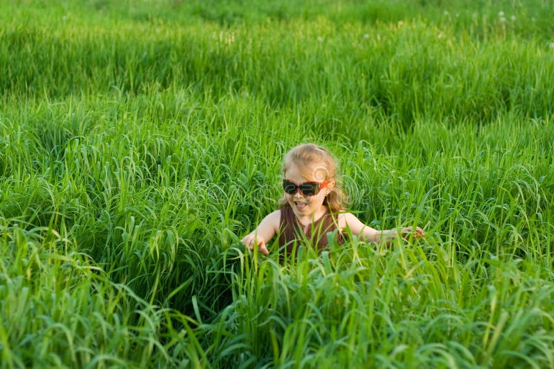 The child in a grass stock image. Image of coast, vegetation - 5389773