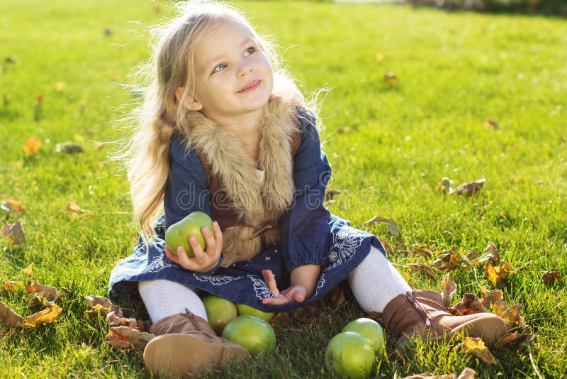 Child with Green Apples Sitting on Grass Stock Image - Image of eating ...