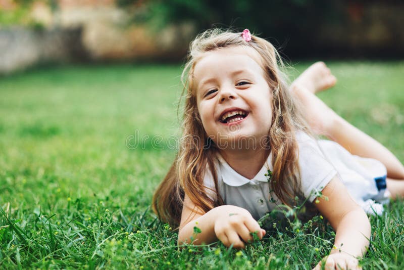 Child on green grass stock image. Image of green, adorable - 74209585