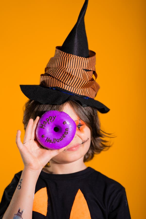 Child with Halloween Donut Doing Poses on Orange Background Stock Image ...