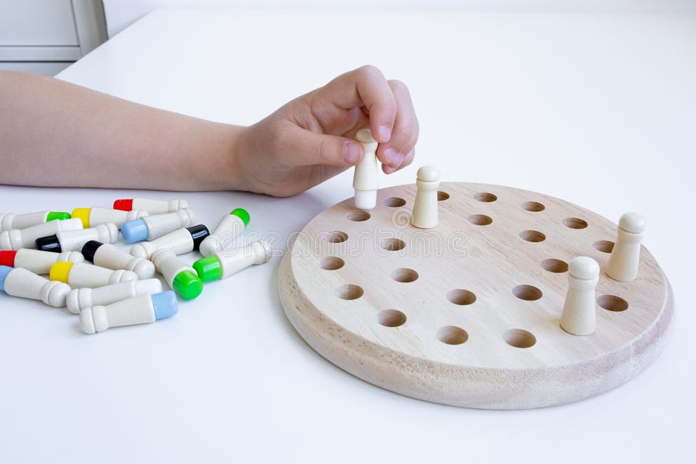 Child Hand Engaging with Wooden Peg Puzzle for Cognitive Development ...