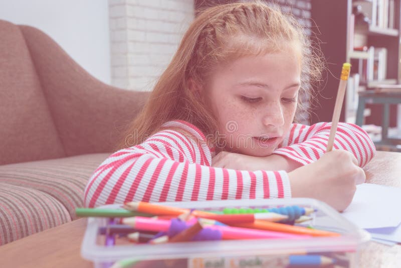 Child Hand Using Color Pencil To Practice Writing on a Paper. Stock ...