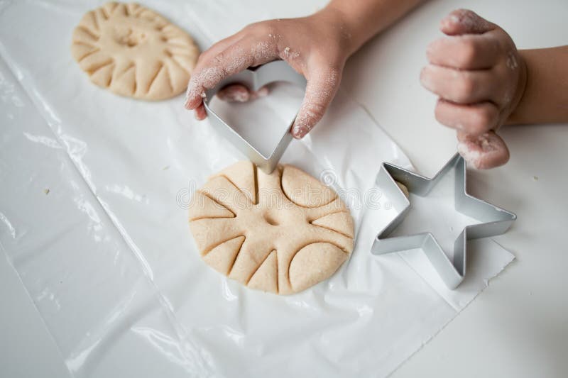 Child Hands Creating Star Shaped Cookies on Plastic Sheet with Cookie ...