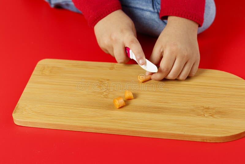 Child Hands Cutting Baby Carrots on Table Stock Image - Image of chef ...